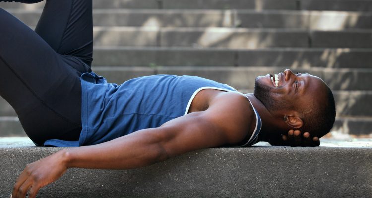 Smiling man lying down on back outside | Wenatchee Outdoors